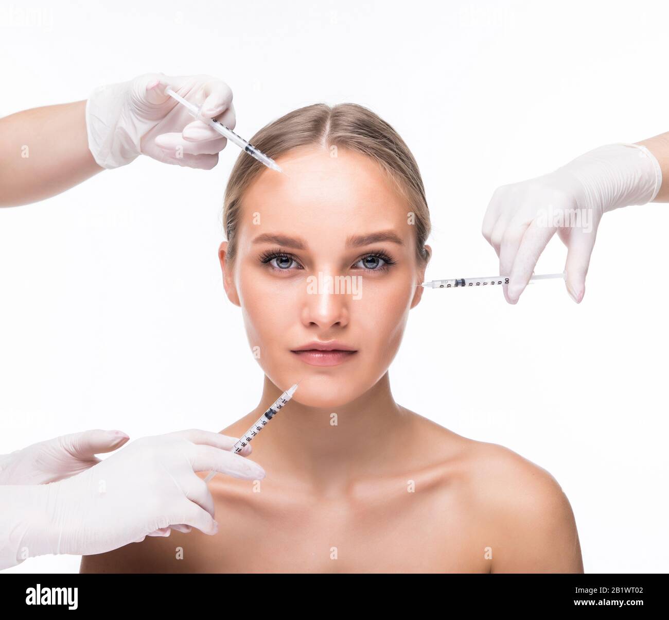 Asain young woman gets injection in her lips. Woman in beauty salon ...