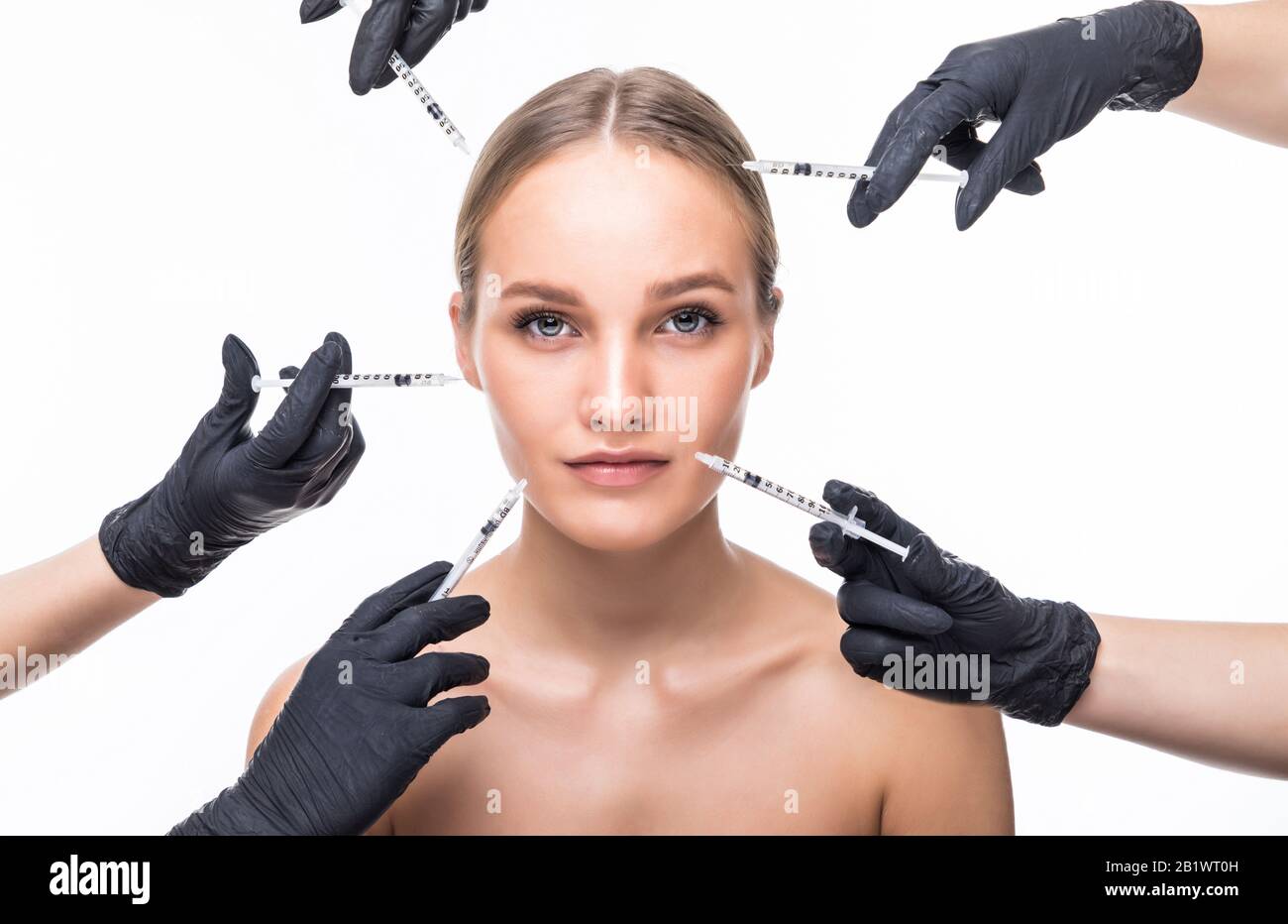 Asain young woman gets injection in her lips. Woman in beauty salon ...