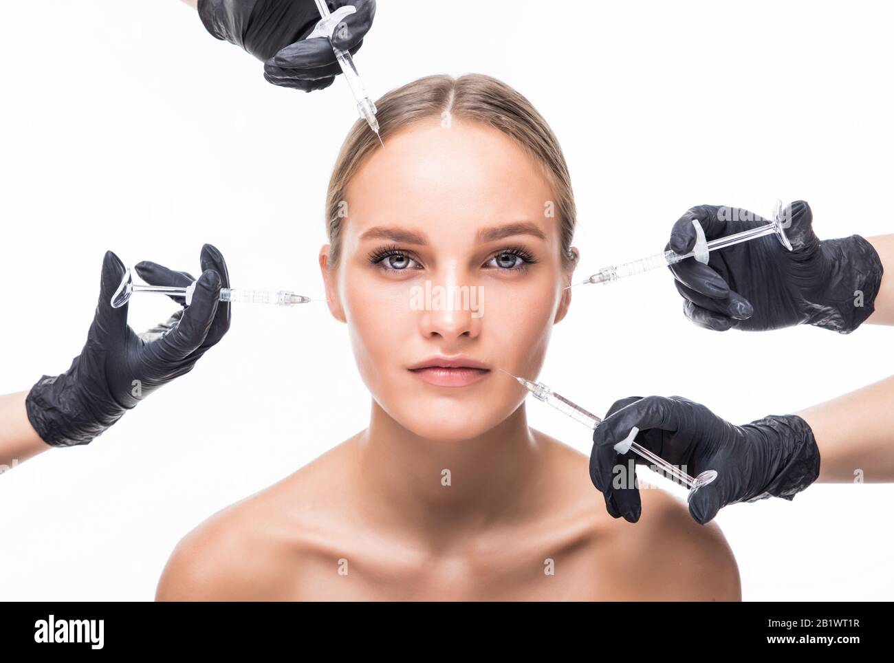 Asain young woman gets injection in her lips. Woman in beauty salon ...