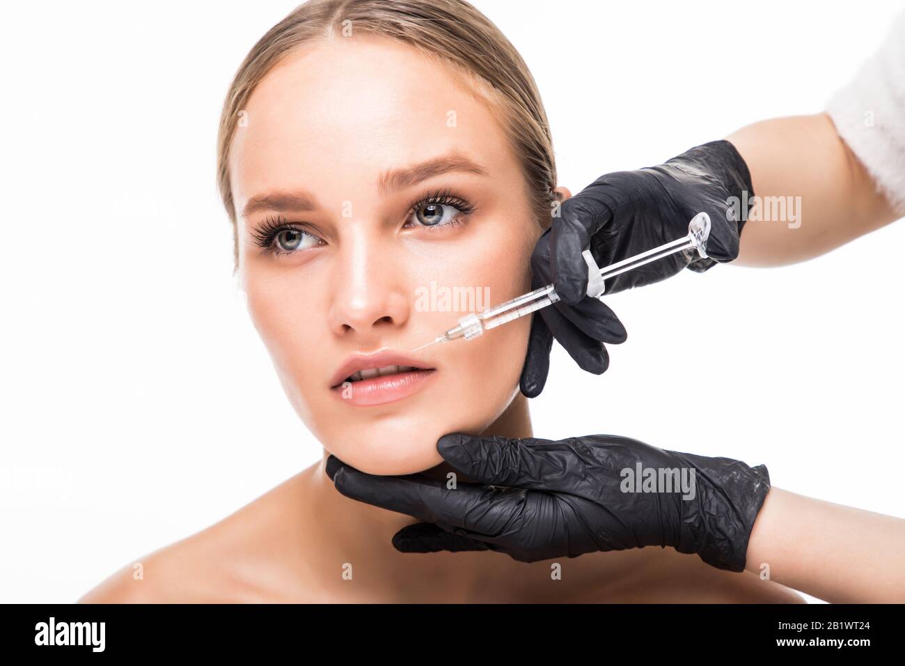 Portrait of young woman getting cosmetic injection. Closeup of ...