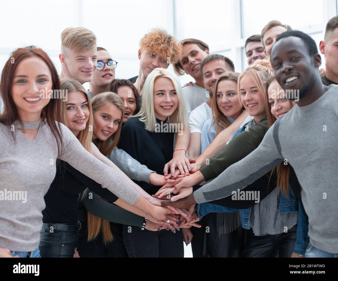 diverse young people putting their hands together Stock Photo - Alamy