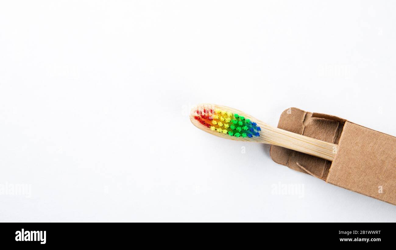 Bamboo toothbrush in a cardboard packaging with copy space on a white ...