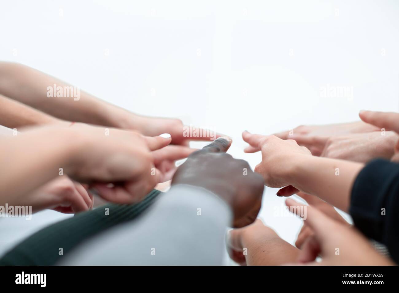close up. a group of young people pointing at one point Stock Photo - Alamy