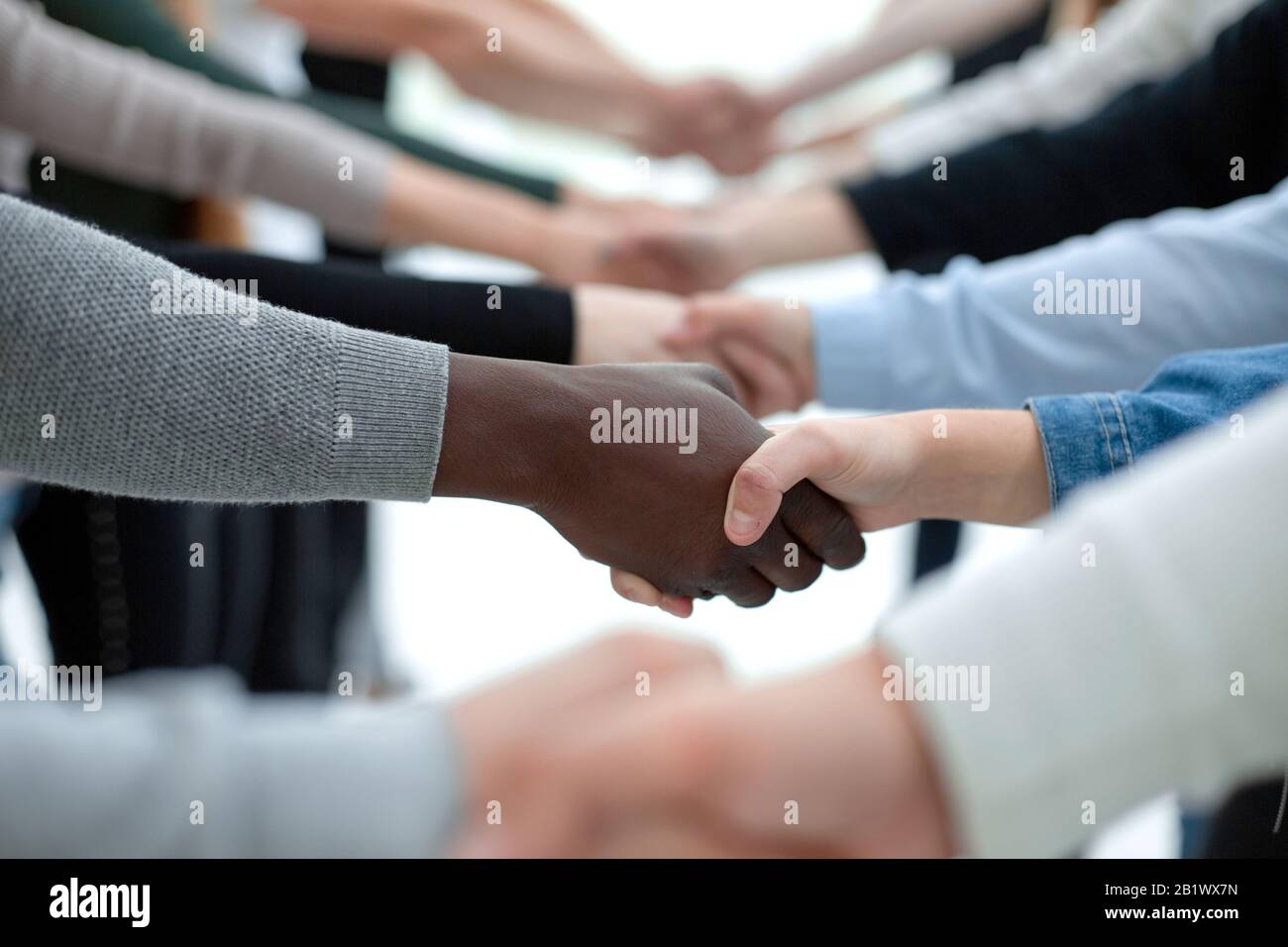 close up. diverse young people shaking hands with each other Stock ...