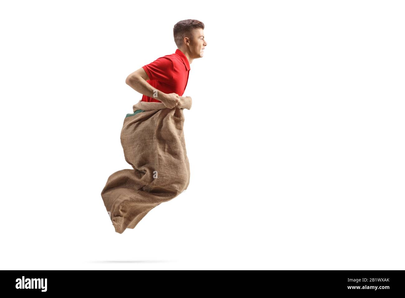 Young guy playing a game with jumping in a sack isolated on white ...