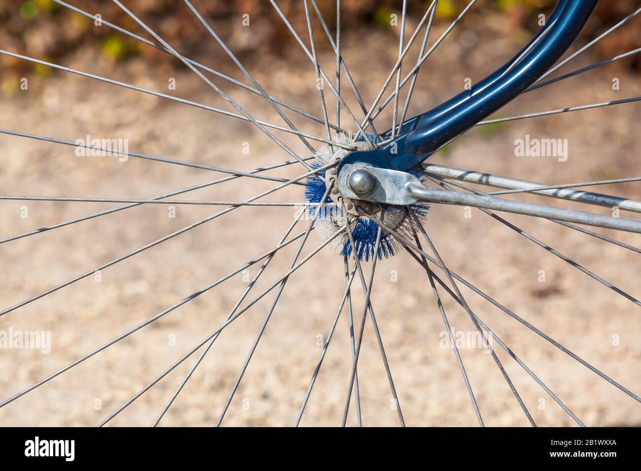Detail axis and spokes of used bicycle front wheel at outdoor ...