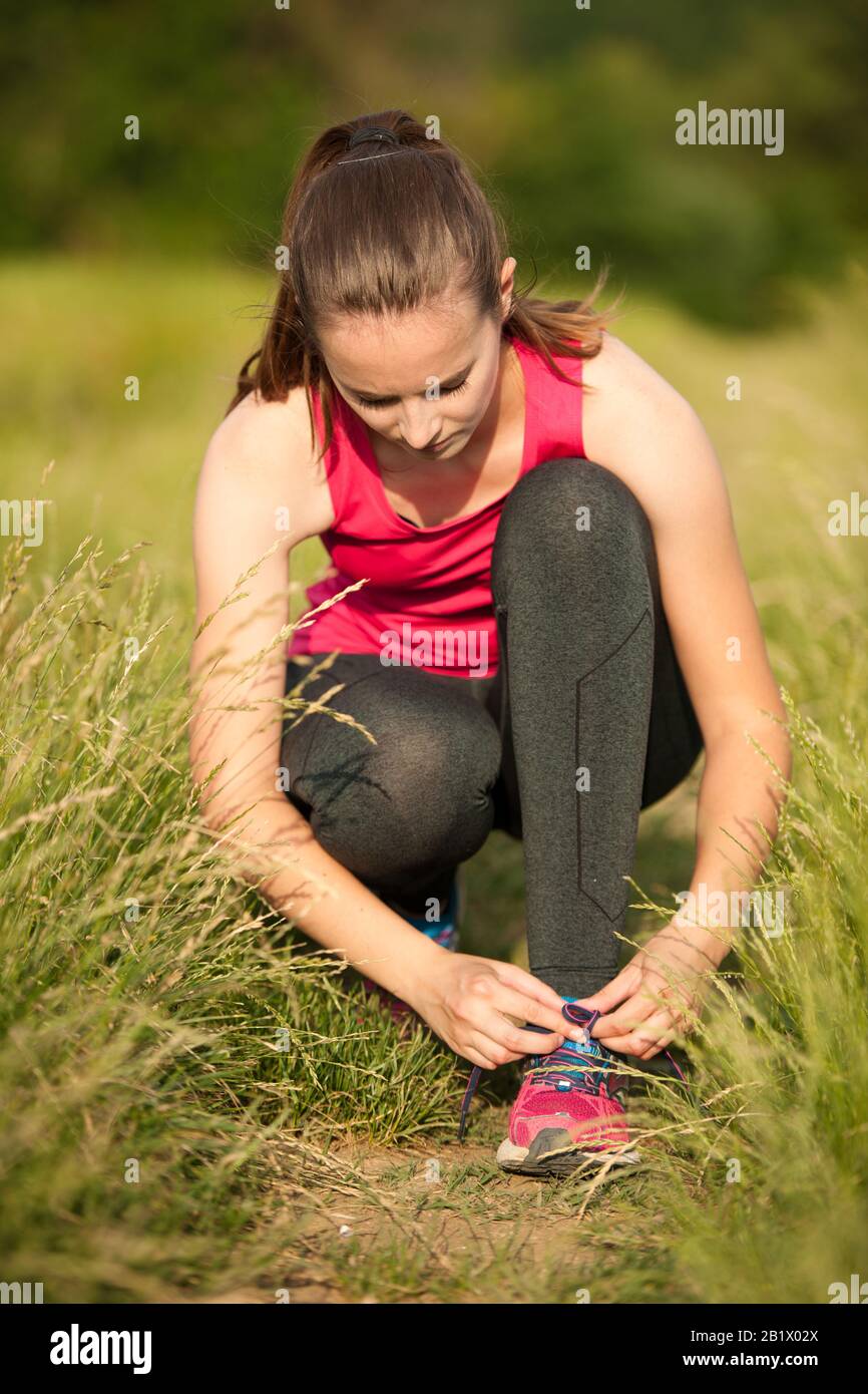 Woman tie jogging shoes hi-res stock photography and images - Alamy