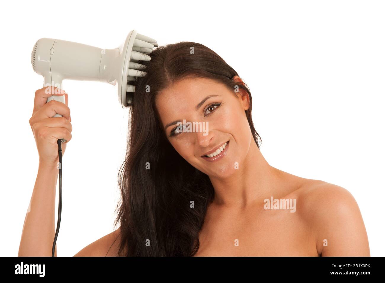 Beautiful young woman drying hair with hair dryer isolated over white ...