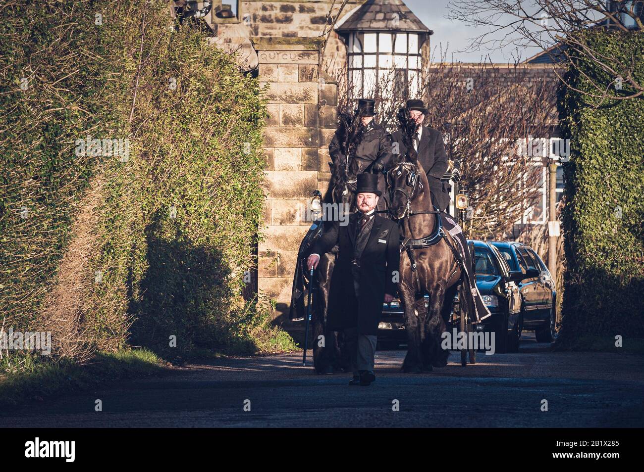 A funeral director, dressed in traditional formal morning dress with ...