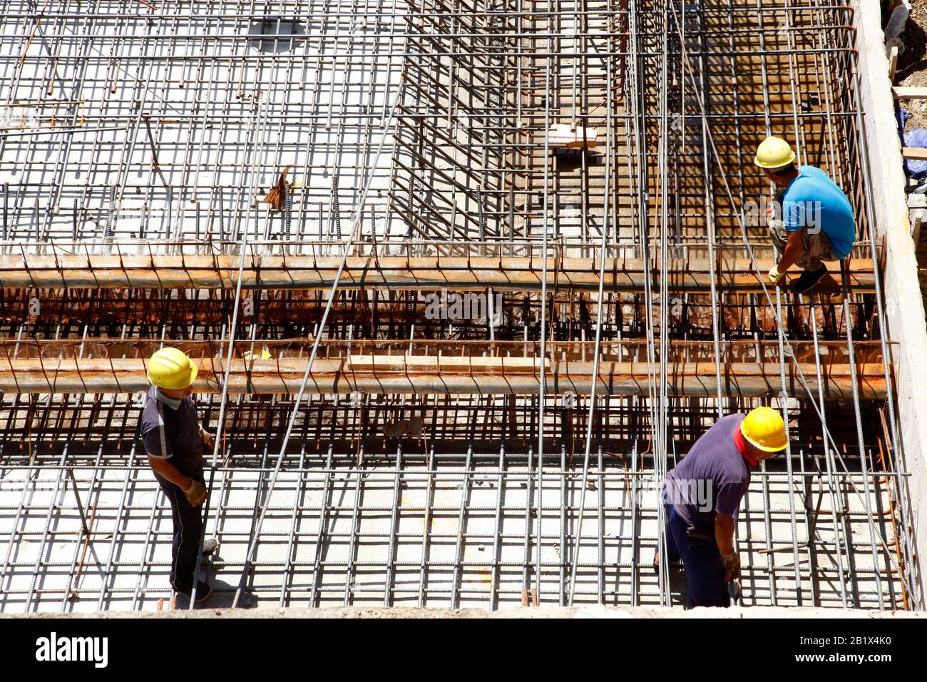 worker in the construction site making reinforcement metal framework ...