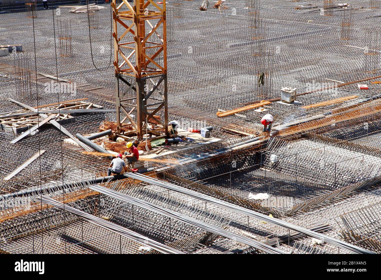 worker in the construction site making reinforcement metal framework ...