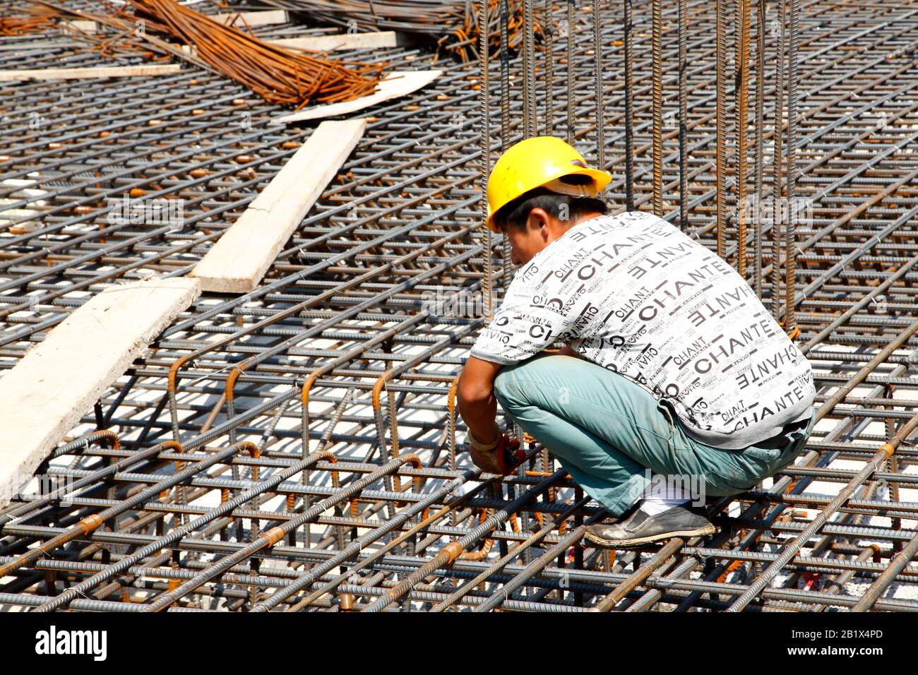 worker in the construction site making reinforcement metal framework ...