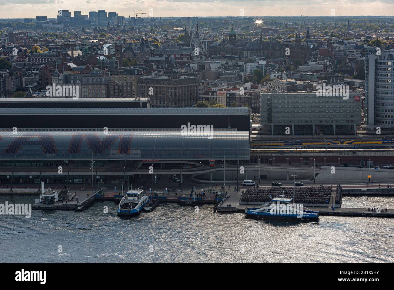 Ferries docked on the river IJ behind the central train station with ...