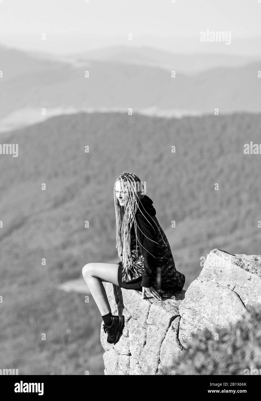 Girl sitting on edge cliff hi-res stock photography and images - Alamy