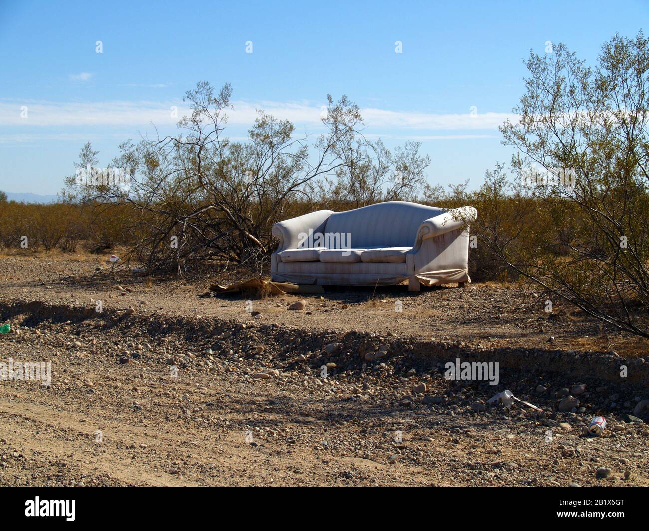An old couch placed near a School Bus stop along a remote road in ...