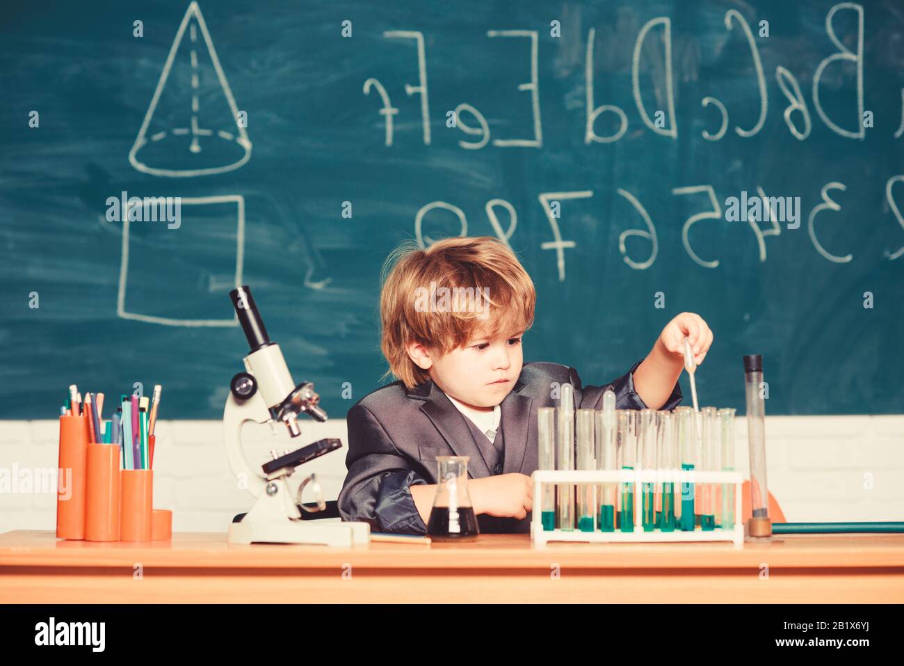 Kid study chemistry school lesson. School education. Boy use microscope ...