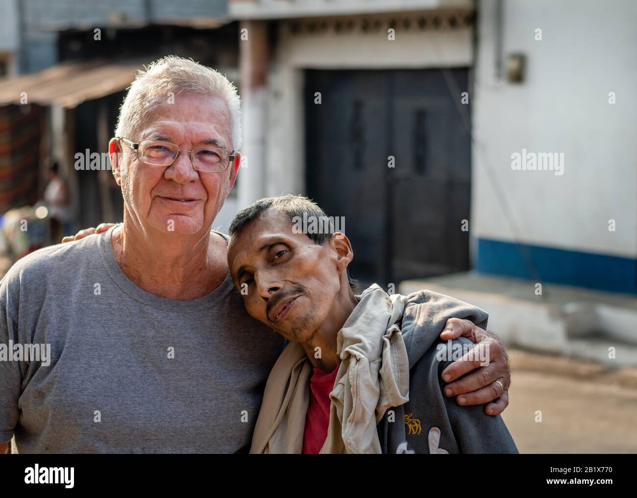 elderly caucasian man takes photo with homeless hispanic man after ...