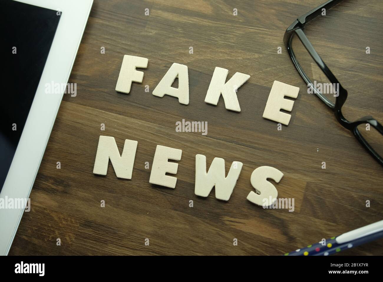 fake news text on wooden table , close up Stock Photo - Alamy