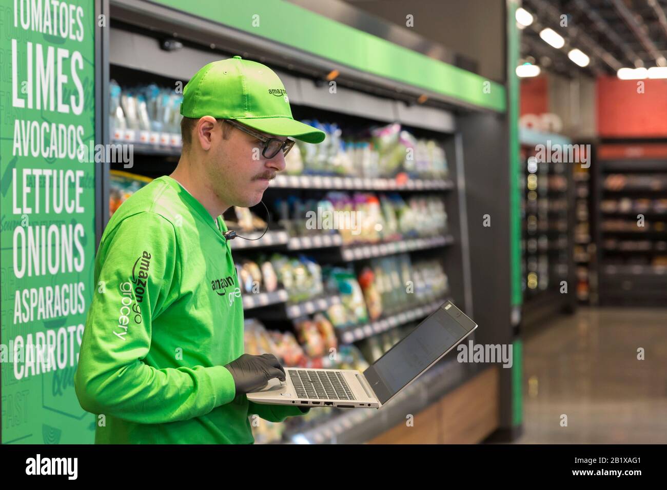 An employee works on a laptop at Amazon Go Grocery on February 27, 2020 ...