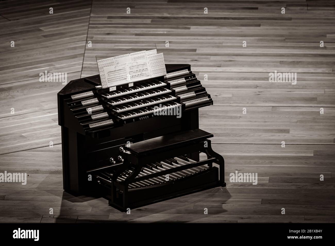 a modern electric organ is placed on the stage lit by lights, waiting ...