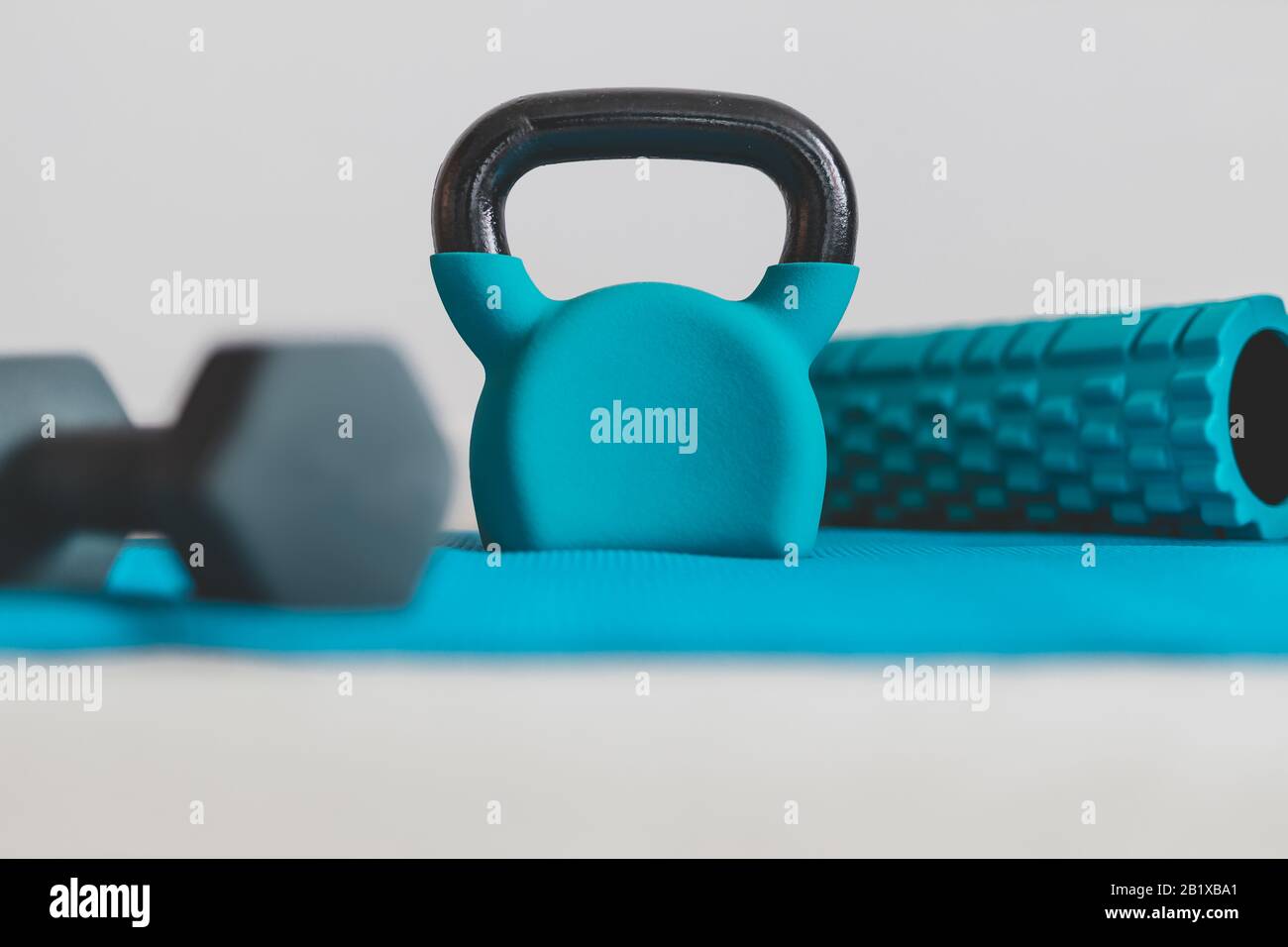 home gym and fitness routines concept, blue yoga mat with kettlebell ...