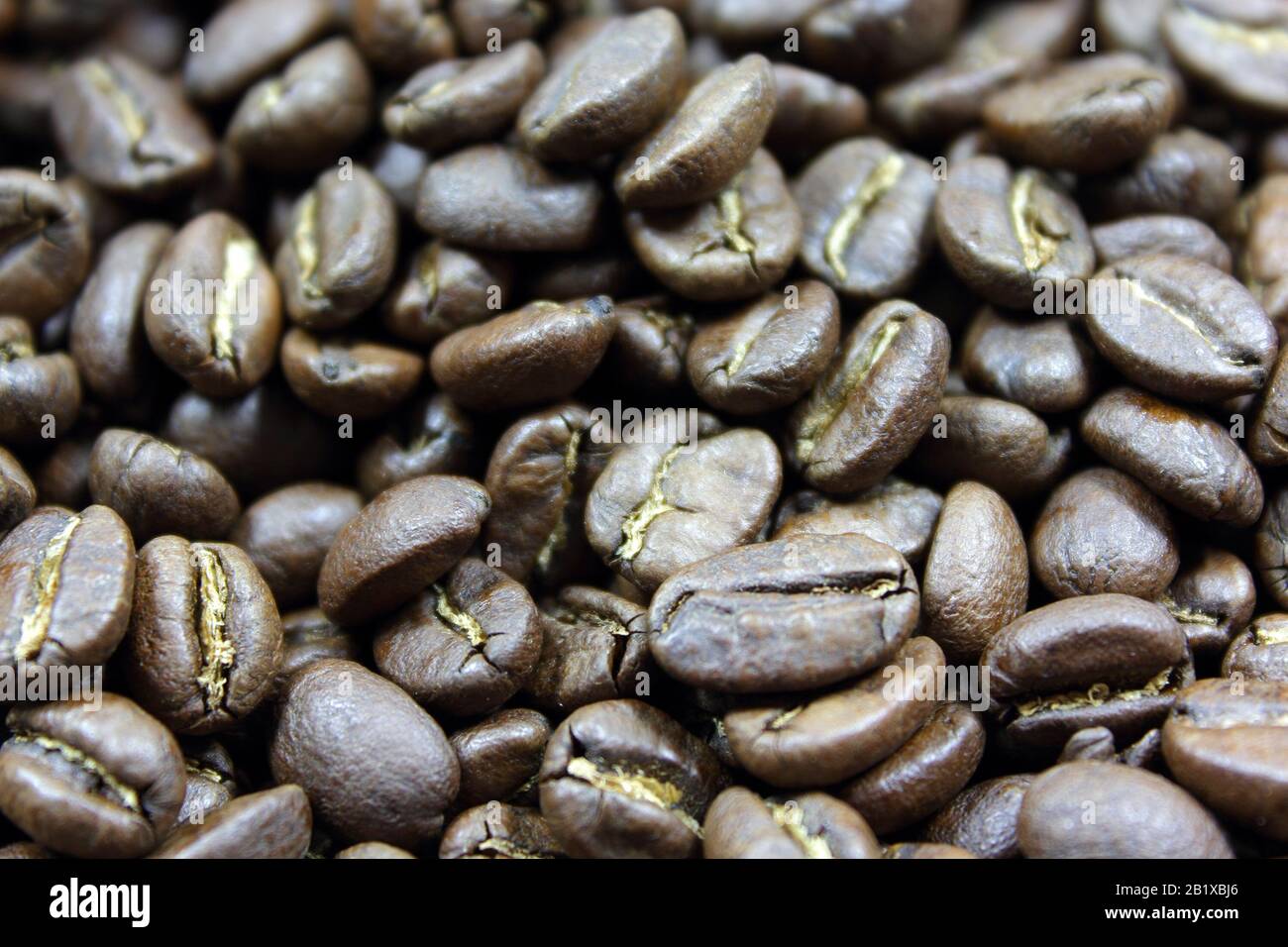 A background of dark roasted coffee beans Stock Photo - Alamy