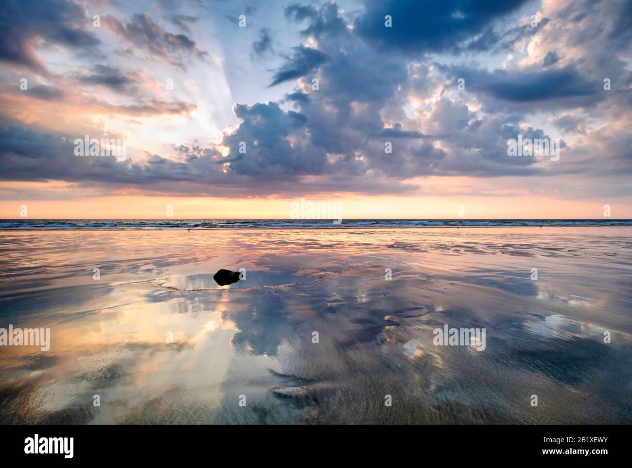 Dramatic sunset skies over the beach, coast, coastal living ...
