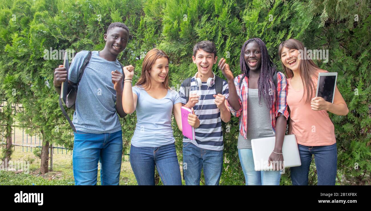 Group of mixed races teenagers happy smiling outdoor in the garden ...