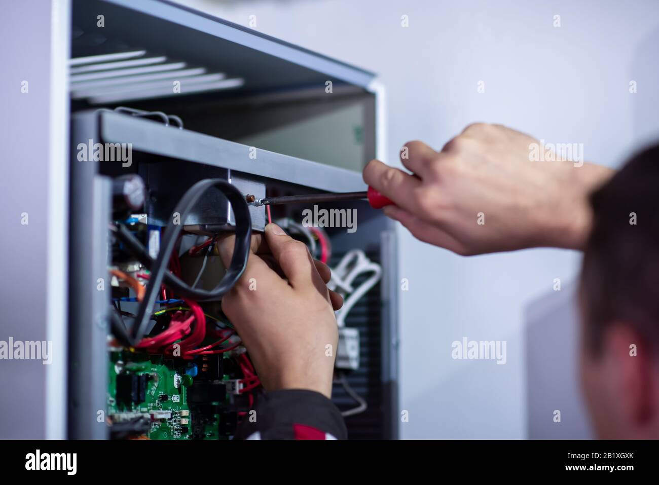 Closeup of electrician engineer working with electric cable wires of ...