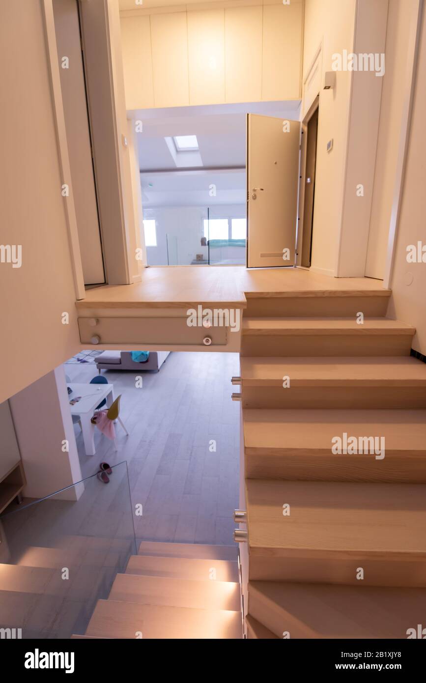 stylish interior with wooden stairs in big modern two level luxury ...