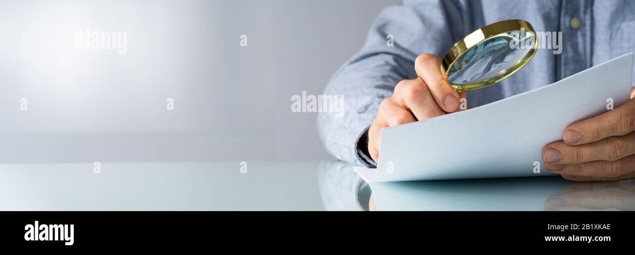 Businessman Looking At Document Through Magnifying Glass Stock Photo ...