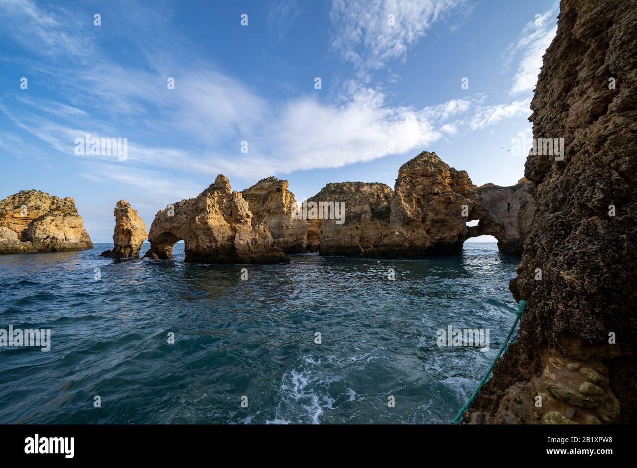 Scenic natural cliff formations and arches of Algarve coastline with ...