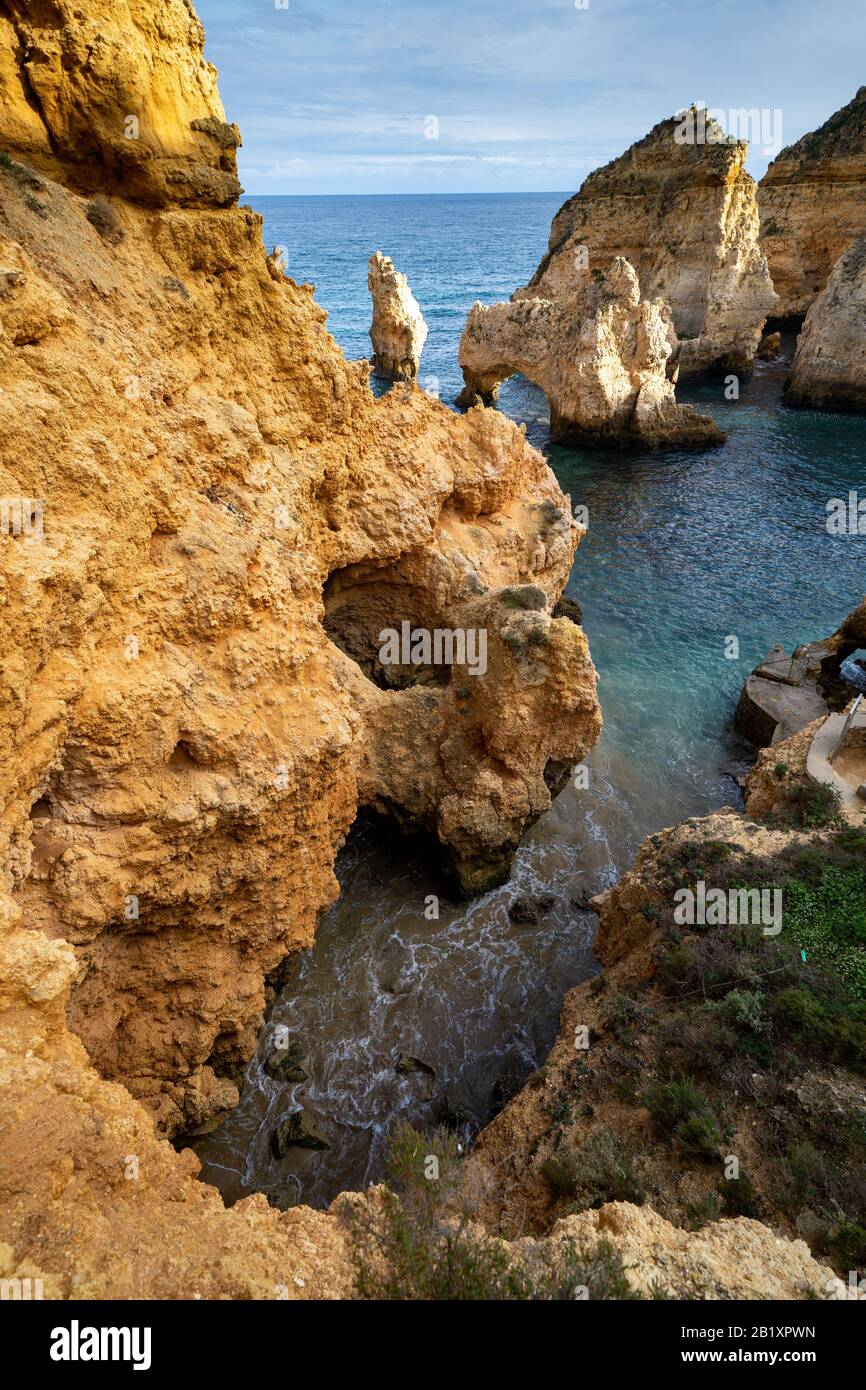 Scenic natural cliff formations and arches of Algarve coastline with ...