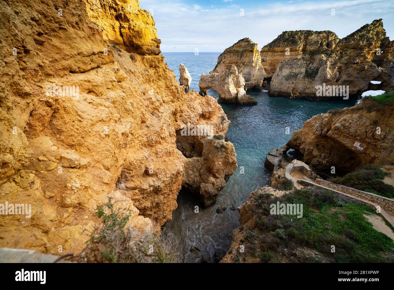 Scenic natural cliff formations and arches of Algarve coastline with ...