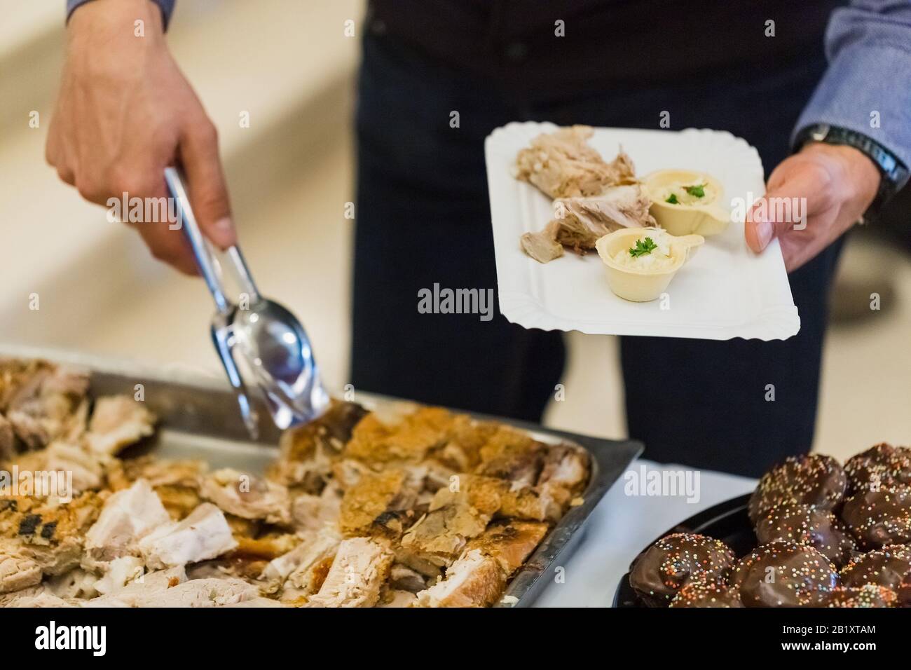 Man serving himself with food on banquet or celebration event Stock ...