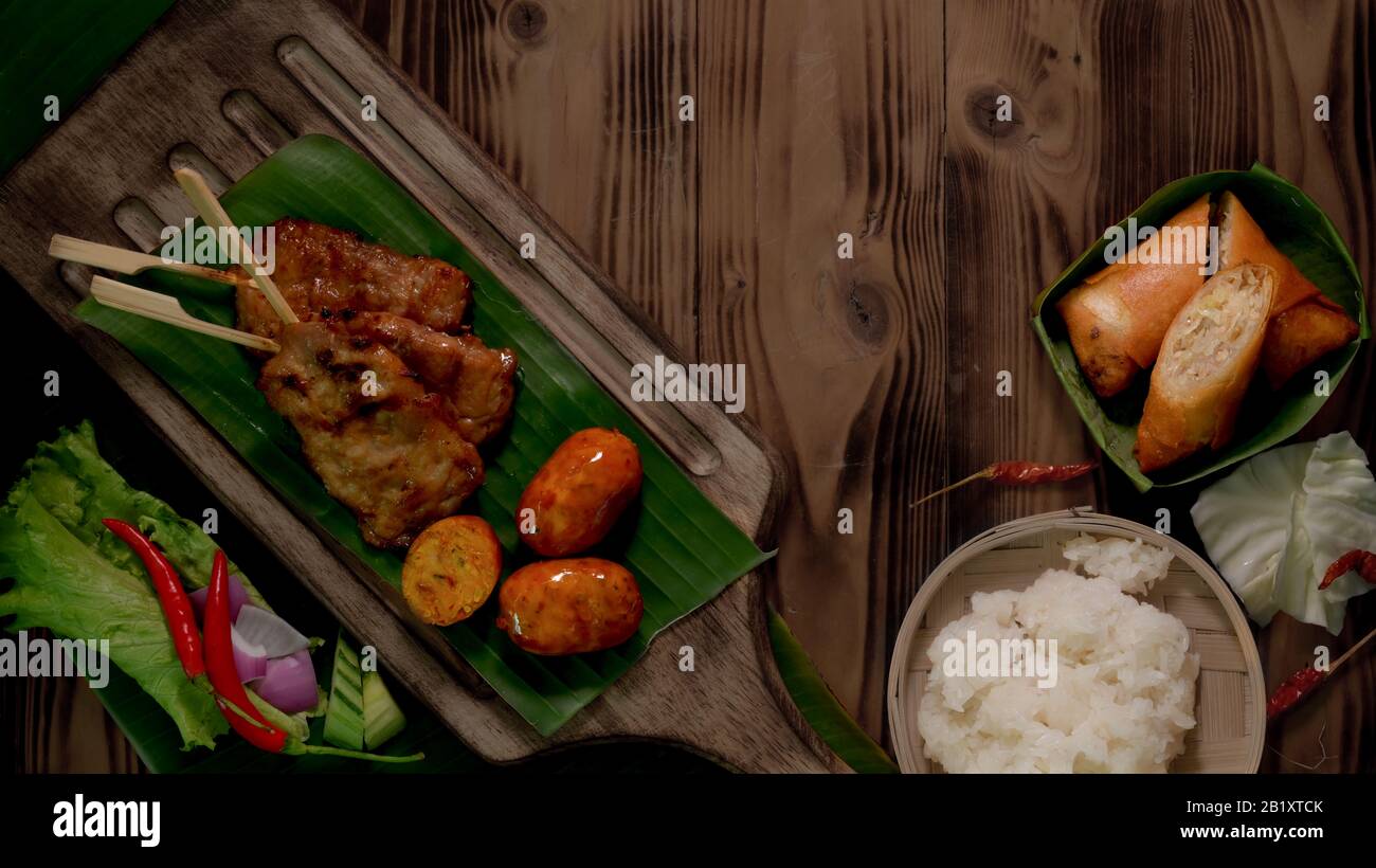 Top view of Thai traditional street food with Moo Ping or grilled pork ...