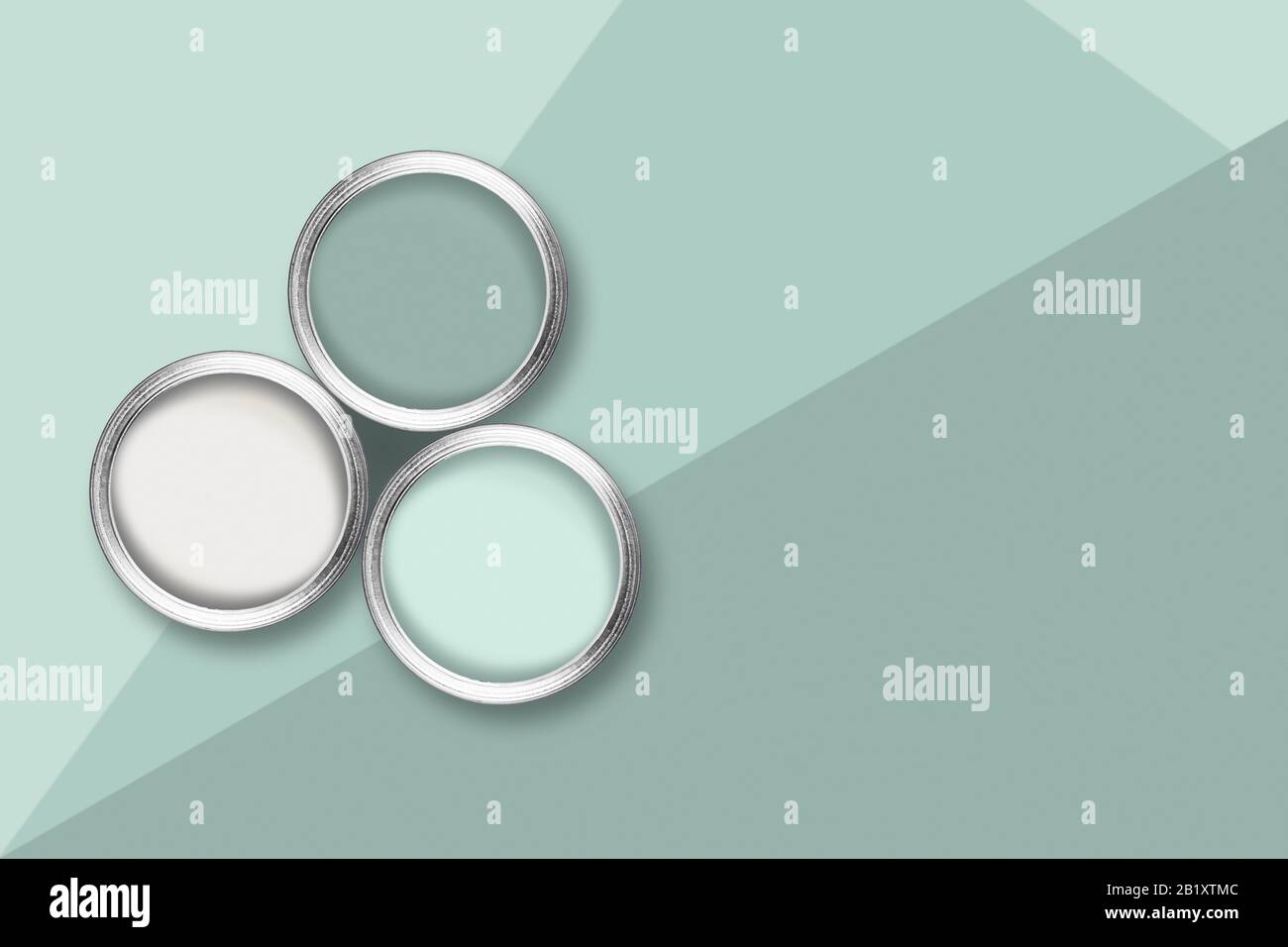 Flat lay picture with three color paint cans on tricolor pastel green ...