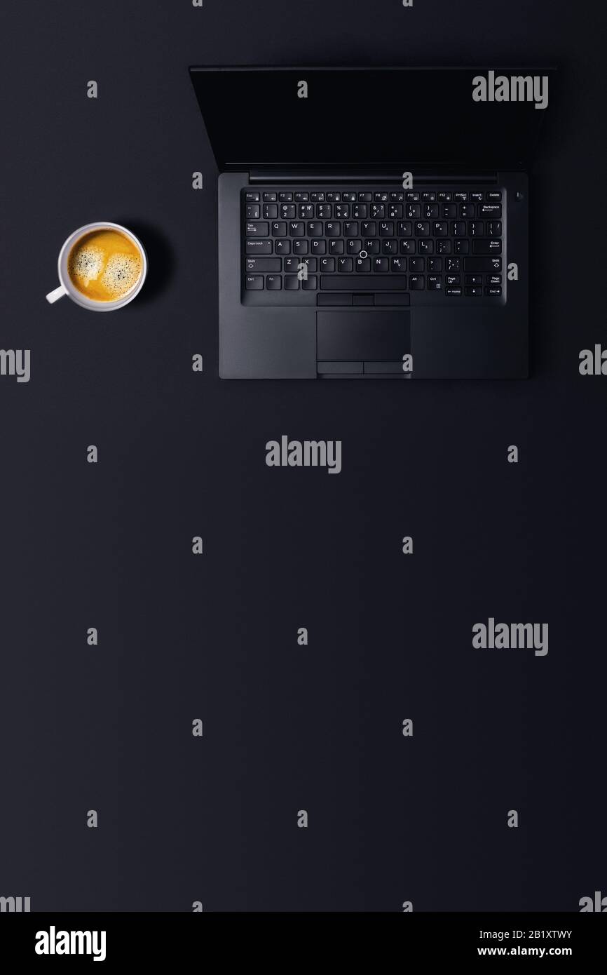 Black desk of work. Workspace on black table with cup of coffee ...