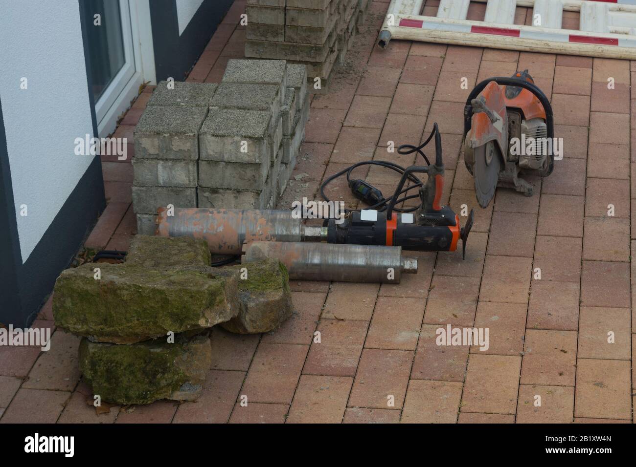 Concrete drilling with industrial boring machine next to it is a stone ...