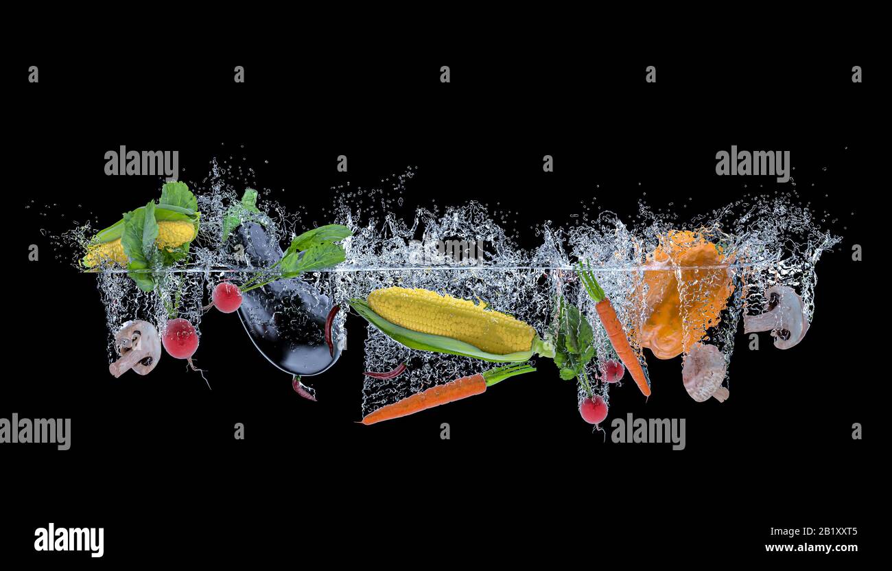 vegetables of different types create splashes by falling into the water ...