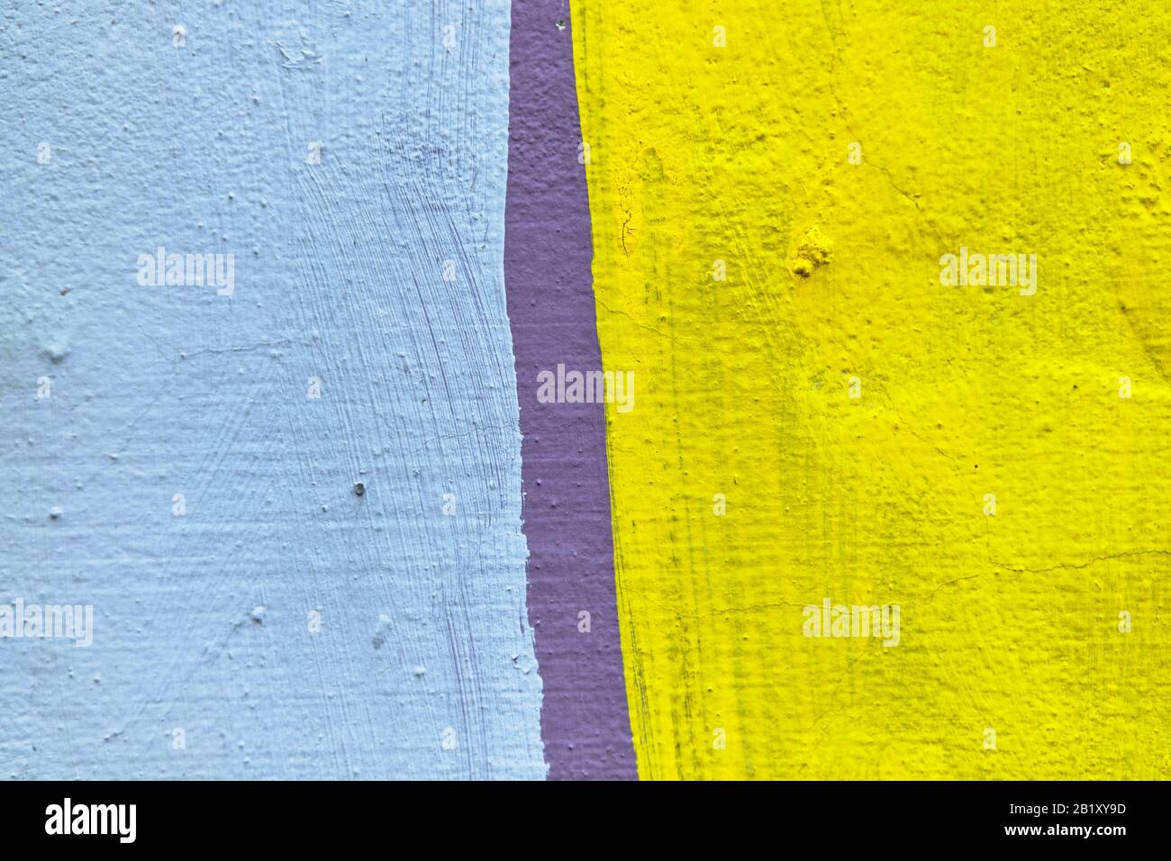 Abstract plaster texture of pale blue and yellow with a purple line ...