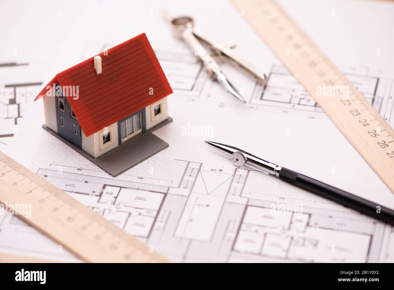 A model house on blueprints with keys to the new home Close up Stock ...