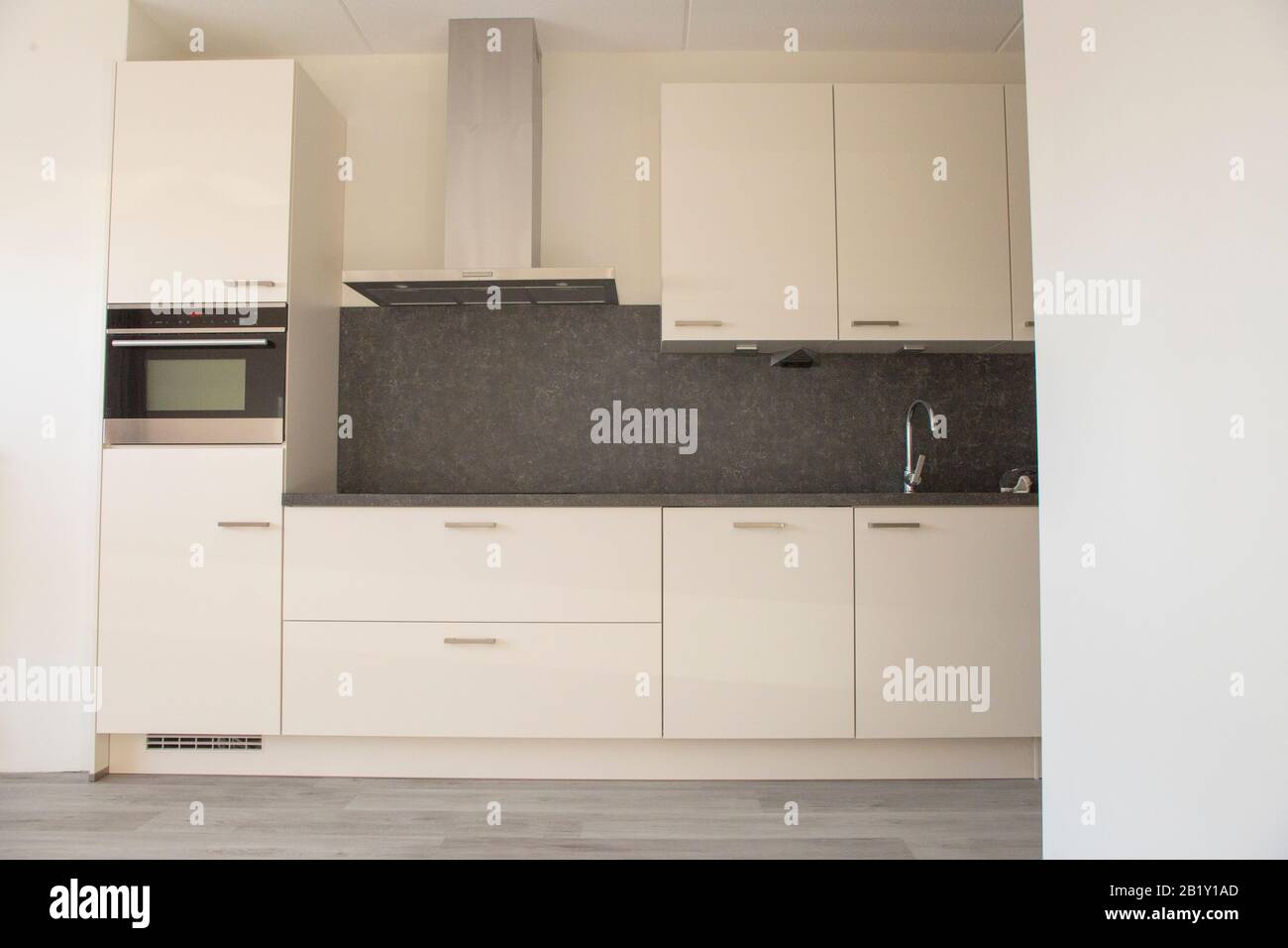 Modern white kitchen in new empty house with wooden floor Stock Photo ...