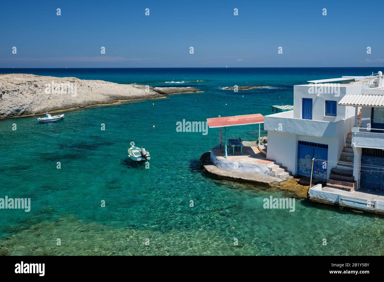 Greece island Milos. Small harbor with fishing boats in water ...