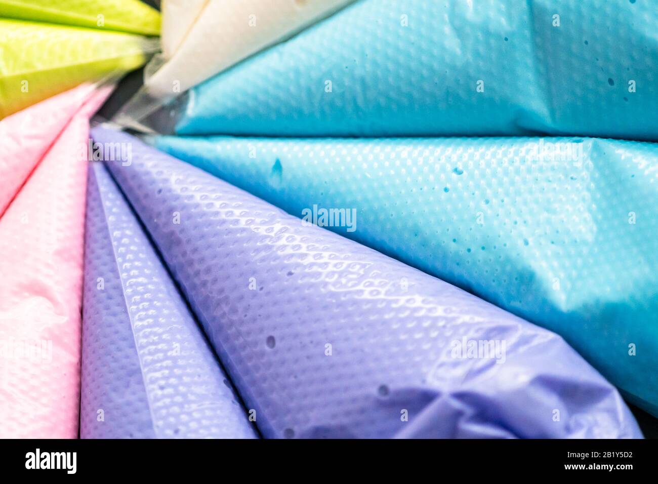 Variety of colors of royal icing in plastic piping bags Stock Photo - Alamy