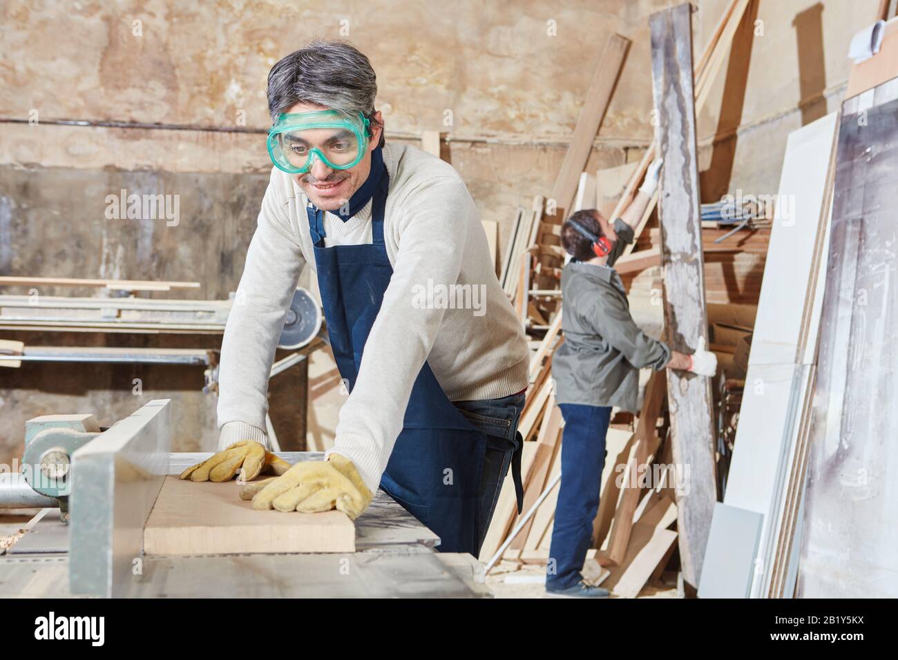 Carpenter planes wood in carpentry with a planing machine Stock Photo ...