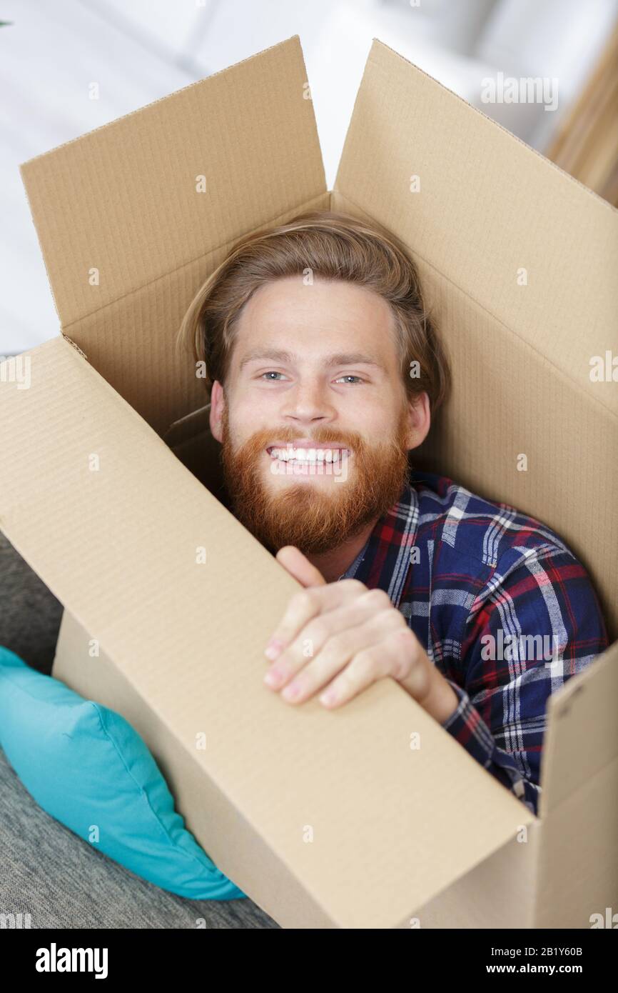 portrait of a handsome young man inside a cardbox Stock Photo - Alamy