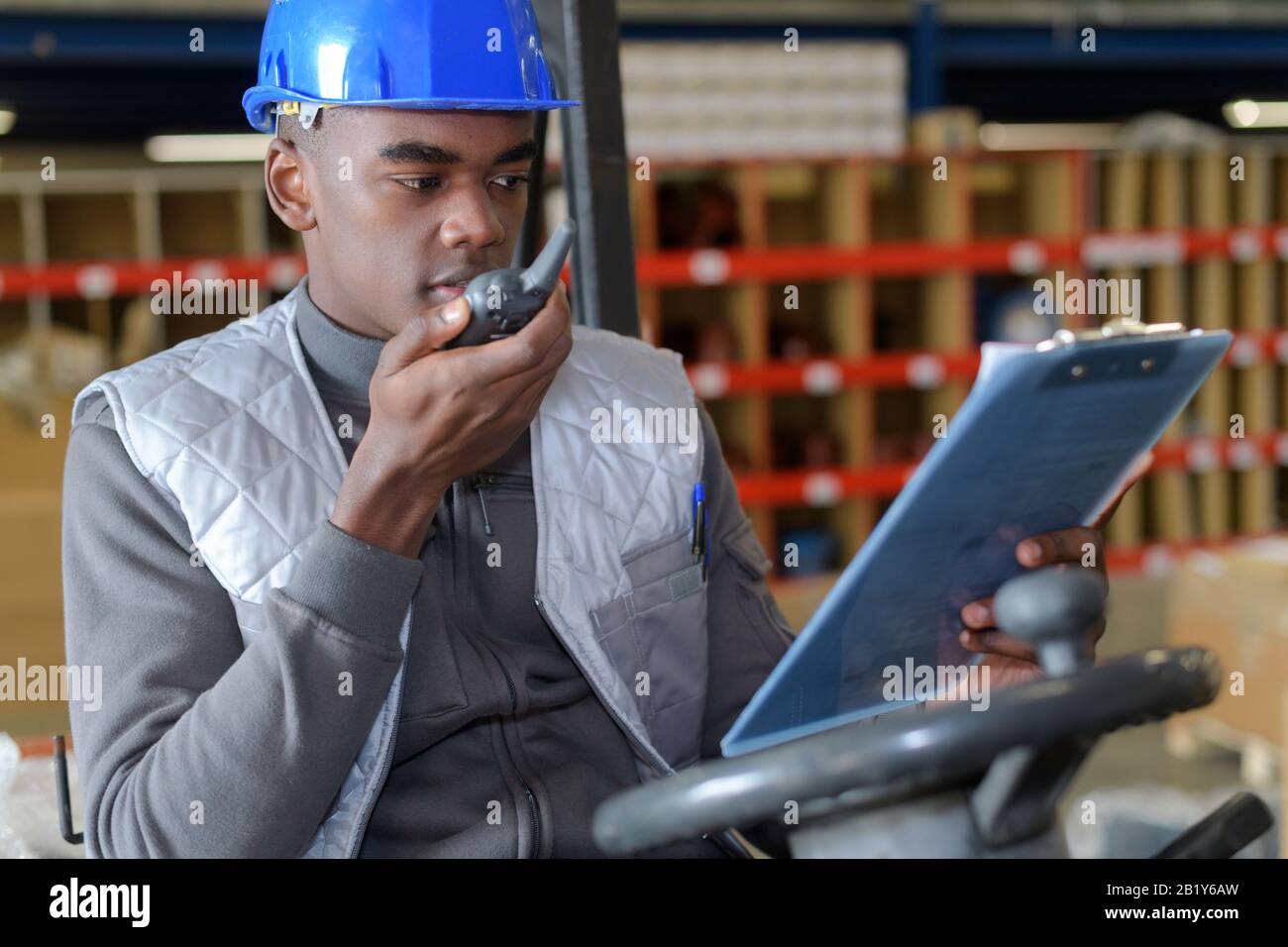 Male construction worker plans phone hi-res stock photography and ...