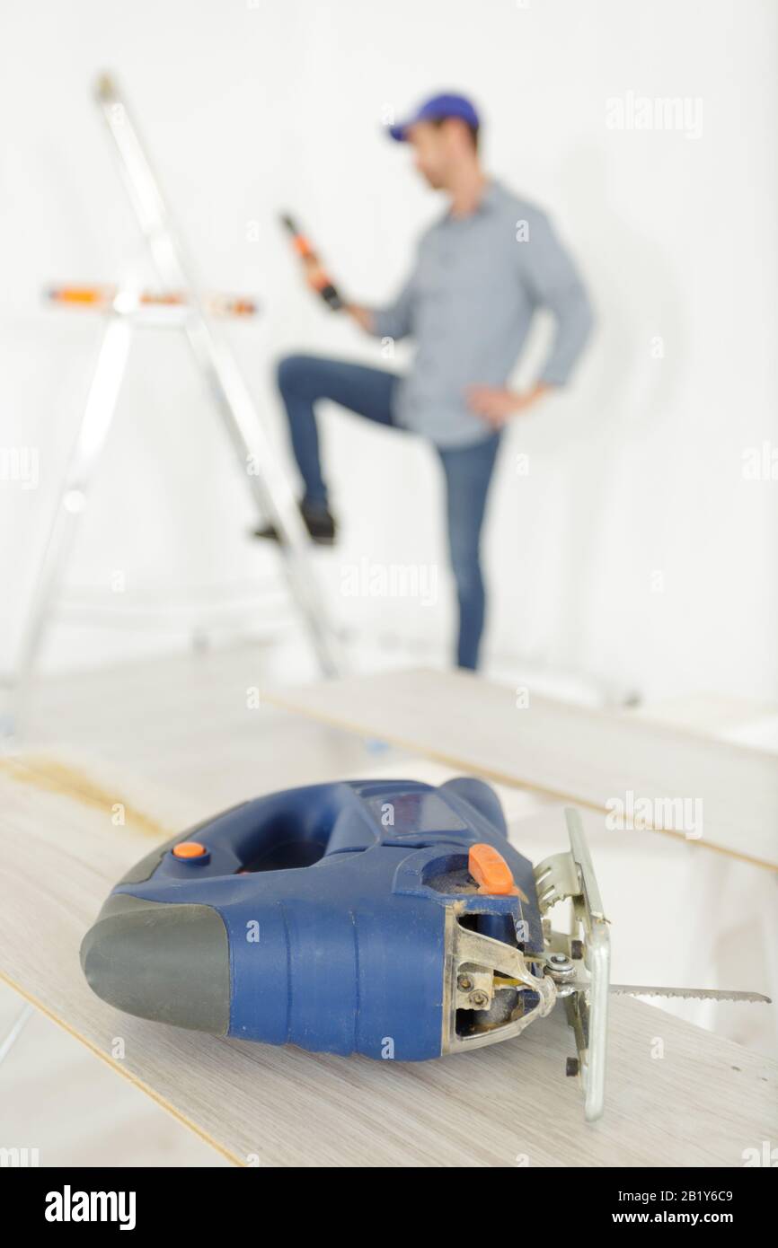 carpenter is cutting wood with machine Stock Photo - Alamy