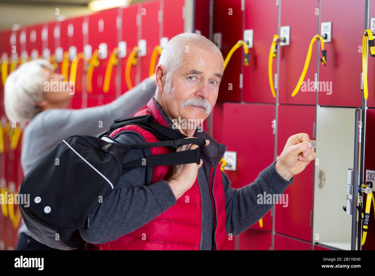 elderly man opening his locker Stock Photo - Alamy
